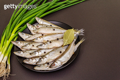 Raw sea fish smelt, sardines, anchovies, capelin with the scent of ...