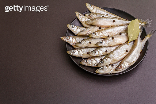 Raw sea fish smelt, sardines, anchovies, capelin with the scent of ...