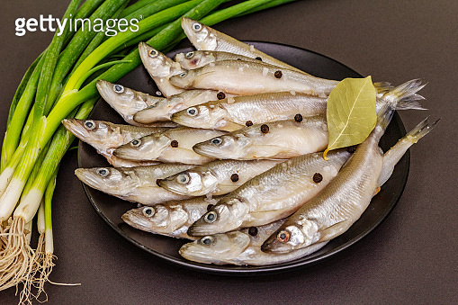 Raw sea fish smelt, sardines, anchovies, capelin with the scent of ...