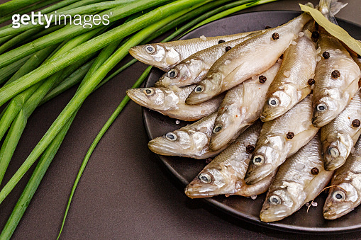 Raw sea fish smelt, sardines, anchovies, capelin with the scent of ...