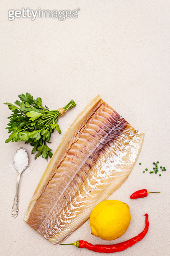 Raw cod loin fillet with lemon, sea salt, chili and cayenne pepper ...