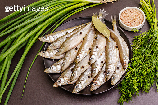 Raw sea fish smelt, sardines, anchovies, capelin with the scent of ...