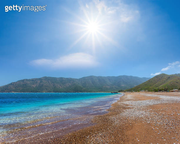 beautiful summer emerald sea bay with green mountain under a sparkle ...