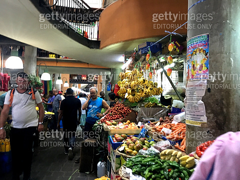 People buying fruits and vegetables in the crowded central market in ...