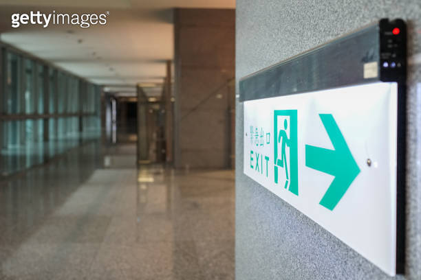 Emergency exit, escape route sign. Location in modern building in ...