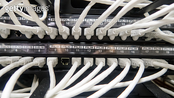 Modern Network panel, switch and lan cable in data center server room ...