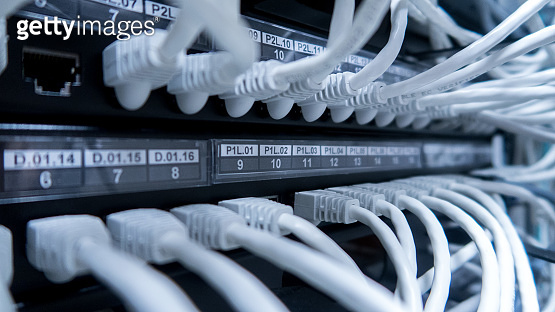 Modern Network panel, switch and lan cable in data center server room ...