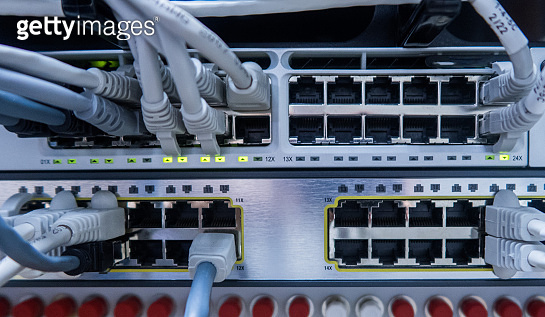 Modern Network panel, switch and lan cable in data center server room ...