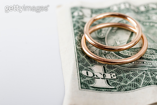 Two wedding rings and currency. Wedding rings and one dollar. Wedding ...