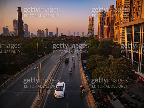 Traffic on a flyover,mill chimney and modern buildings in Mumbai at ...