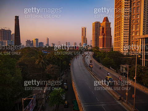 Traffic on a flyover,mill chimney and modern buildings in Mumbai at ...