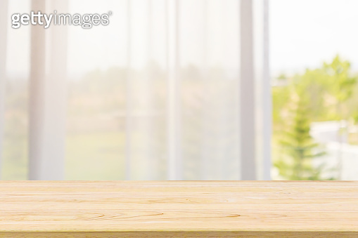Empty wood table top with window curtain abstract blur background for ...