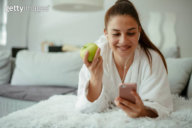 Young bautiful woman texting surfing the net on the sofa at home. stock ...