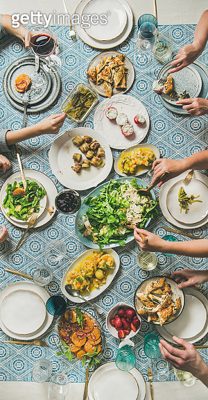Mediterranean style dinner and human hands holding drinks and food 이미지 ...