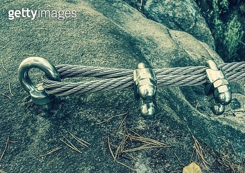 Stainless cable fixed to the rock for the safety 이미지 (1124491599) - 게티이미지뱅크