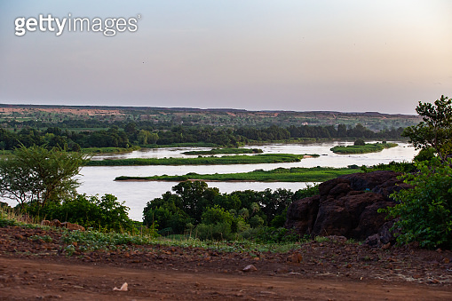 Evening pastel-coloured sky over meanders, islands and green shores of ...
