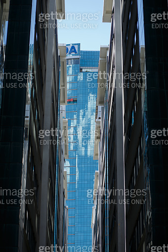 Looking on full glass building between two office buildings in downtown ...