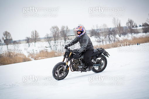 A guy rides a motorcycle on a frozen lake (1170755212) - 게티이미지뱅크