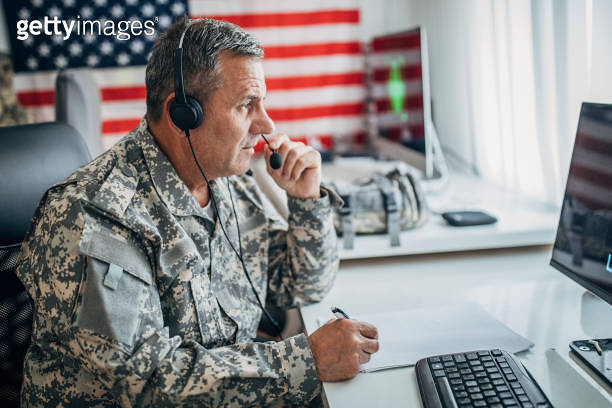Army soldier wearing headphones and writing notes 이미지 (1167998655) - 게티 ...