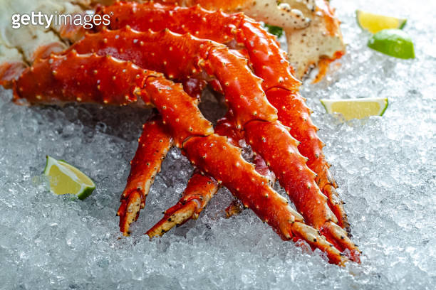large red Kamchatka crab claws phalanx legs tentacles, lies on ice ...
