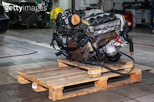 Replacement engine used on a pallet mounted for installation on a car ...