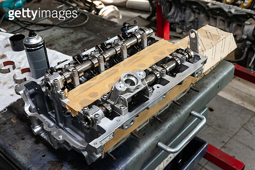 A four-cylinder engine with new camshaft dissembled and removed from ...