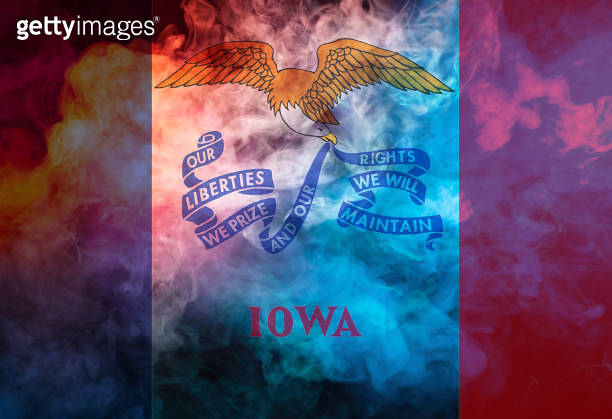 The national flag of the US state Iowa in against a gray smoke on the ...