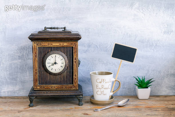 Good morning routine concept with stylish coffee mug, vintage clock and ...
