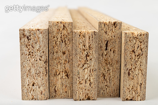 Particleboard with veneer is cut into small pieces. Materials for ...