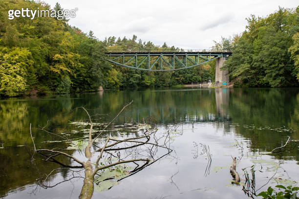 The railway bridge seen from the backwaters on the river. Steel river ...