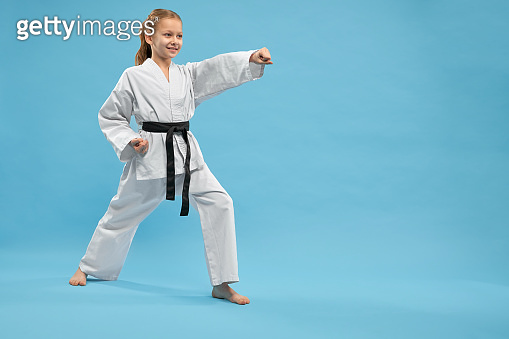 Cheerful female fighter standing in stance and punching (1149012788 ...