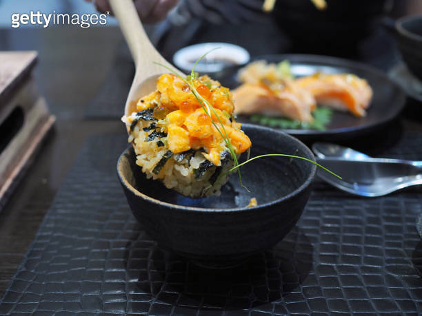 A japanese hot pot of salmon aburi or grilled topped with salmon roe ...