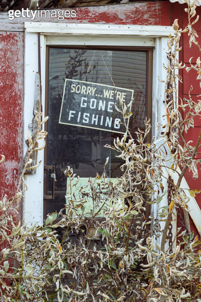 A sign board on a door saying Sorry We Are Gone Fishing in Nome, Alaska ...