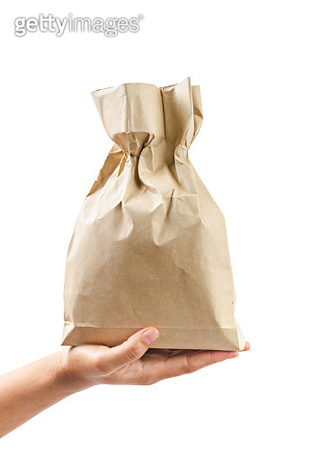 Woman hand holding giving paper bag 이미지 (1171124317) - 게티이미지뱅크