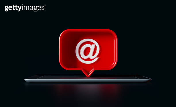 Speech Bubble Shaped Red Button with At Symbol and A Digital Tablet on ...