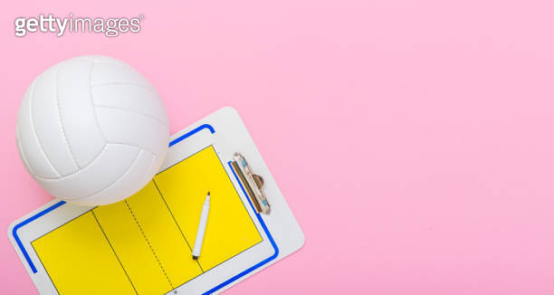 Volleyball and tactical board with marker on pink background. Top view ...