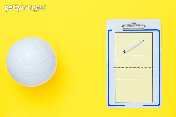 Volleyball and tactical board with marker on yellow background. Top ...