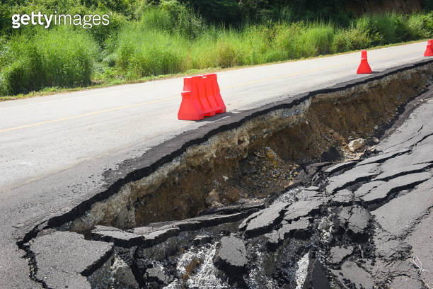 Asphalt road collapsed and cracks in the roadside - Road landslide ...