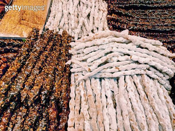 Traditional turkish sweet candy made of grape juice and walnut at ...