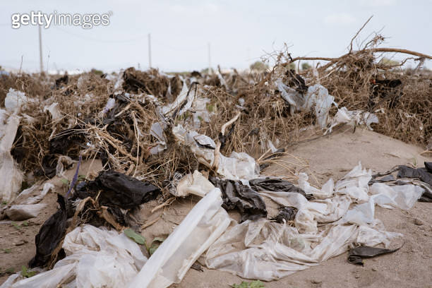 Garbage pile in nature among plants. Toxic plastic into nature ...