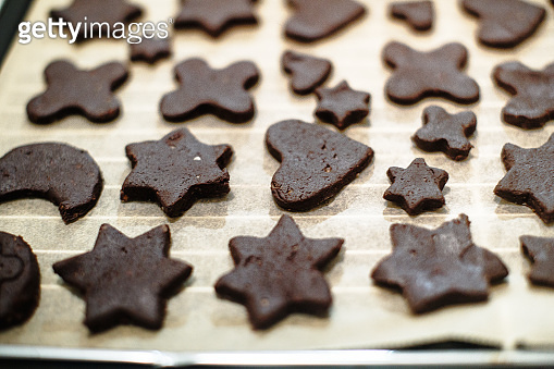 Christmas chocolate biscuits/cookies ready to be cooked in the oven ...