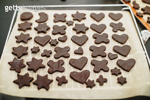 Christmas chocolate biscuits/cookies ready to be cooked in the oven ...
