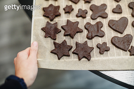 Christmas chocolate biscuits/cookies ready to be cooked in the oven ...