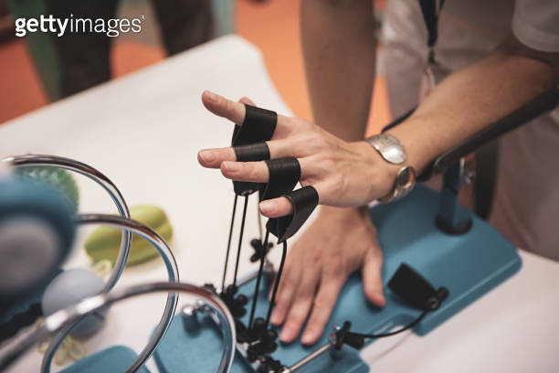 Details with the hand of a woman kinetotherapy medic (physical ...