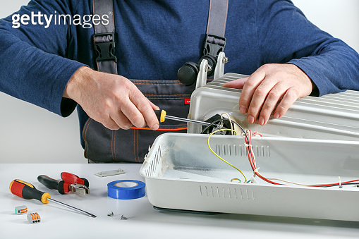 Technician repairing electric heater. Concept repair electricity ...