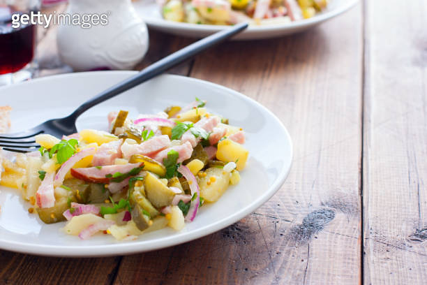 traditional german potato salad with sausage and pickled cucumbers ...