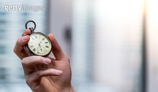 Time goes by: Man is holding a vintage watch in his hand, business ...