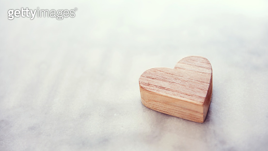 Wood heart shape on marble background in love concept for valentines ...