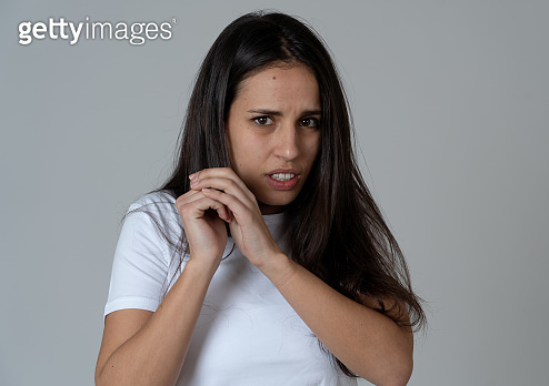 Portrait of young latin woman feeling scared and shocked making fear ...