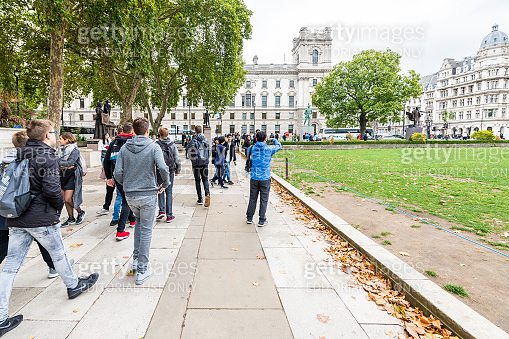 Westminster area with Parliament Square Garden and crowd of young many ...